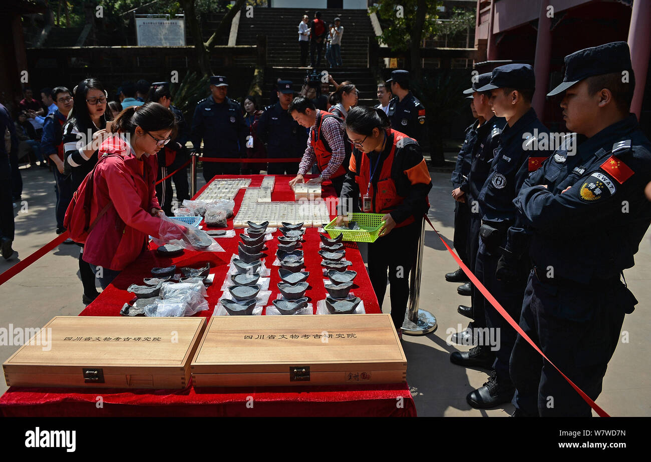 Chinese employees display silver ingots unearthed from the sunken boats ...
