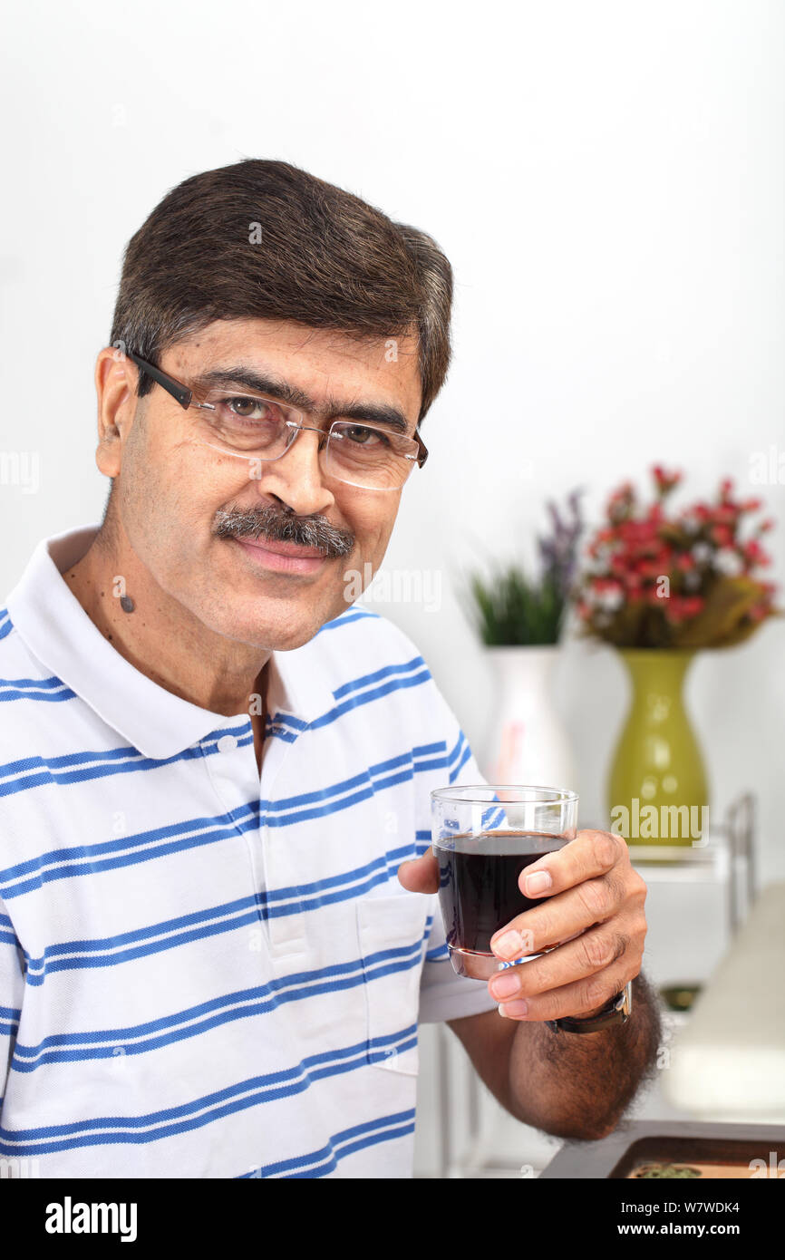 Old man drinking cold drink Stock Photo - Alamy