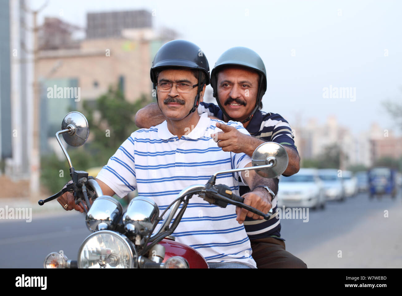 Two friends riding a bike Stock Photo - Alamy