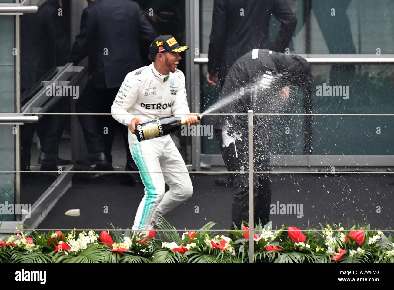 British F1 driver Lewis Hamilton of Mercedes sprays champagne to ...
