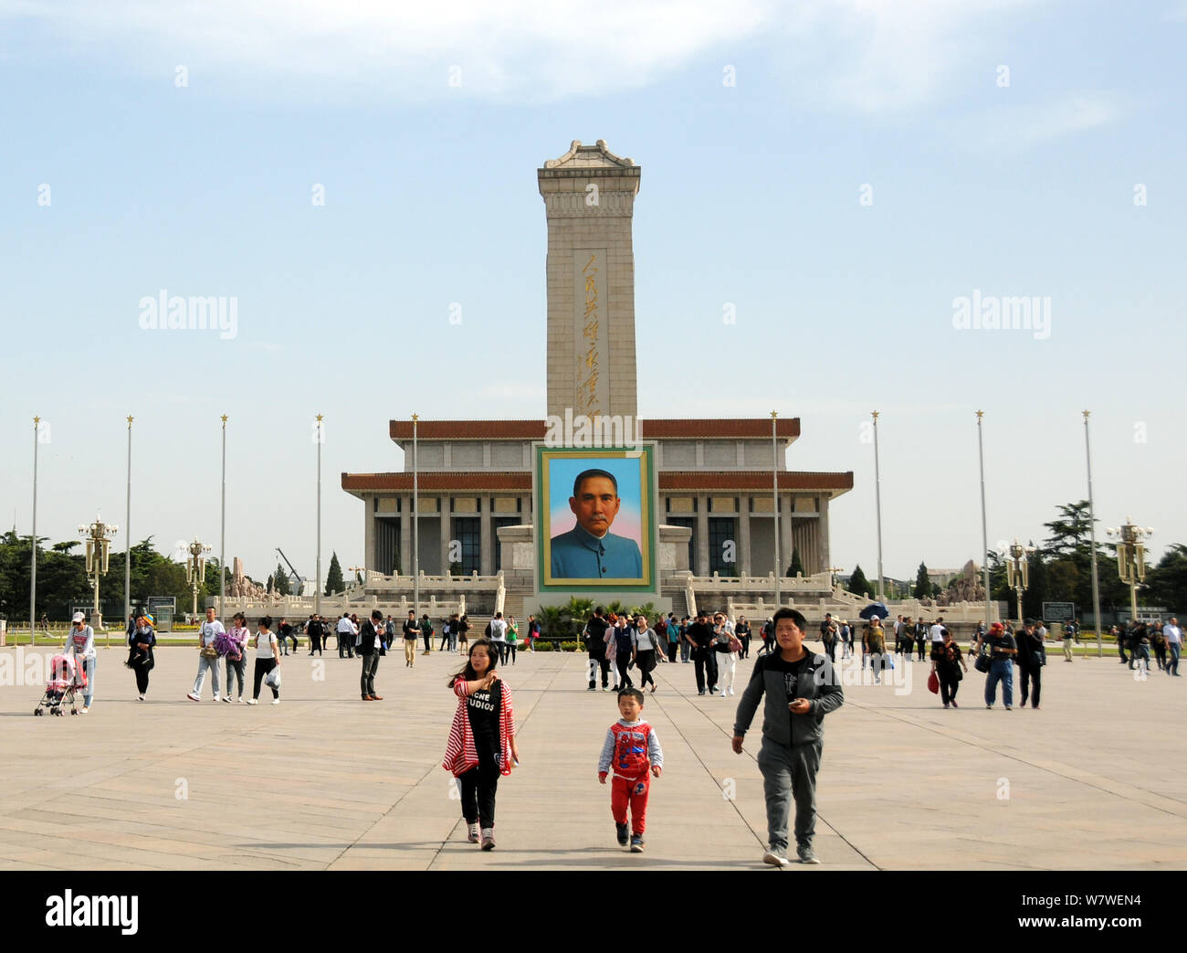 Visitors walk past the huge portrait of Sun Yat-sen, first president ...