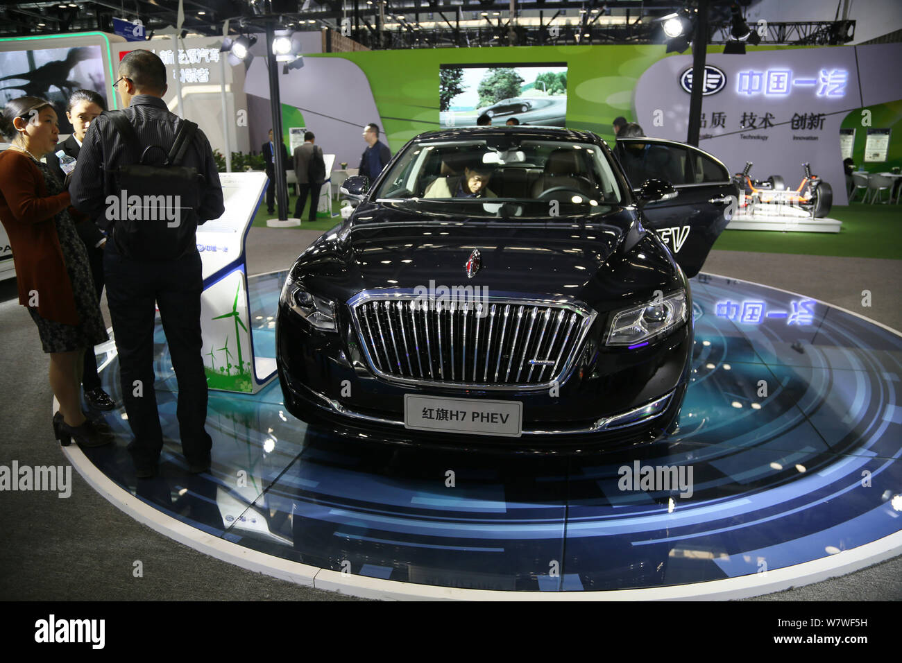 --FILE--Visitors look at a Hongqi (Red Flag) H7 PHEV vehicle of FAW during an automobile ...