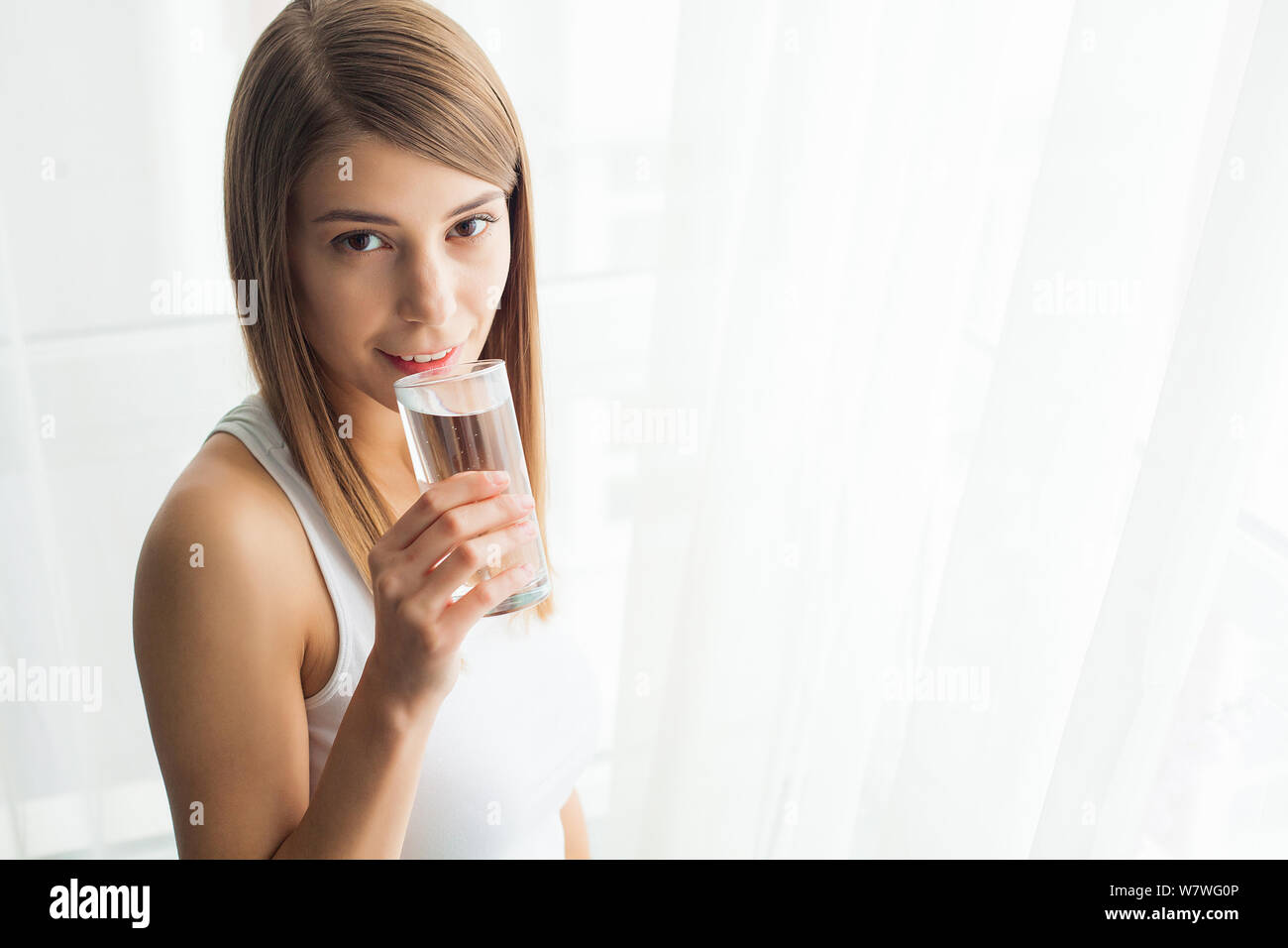 Young woman drinking water. Drinking fresh water Stock Photo - Alamy