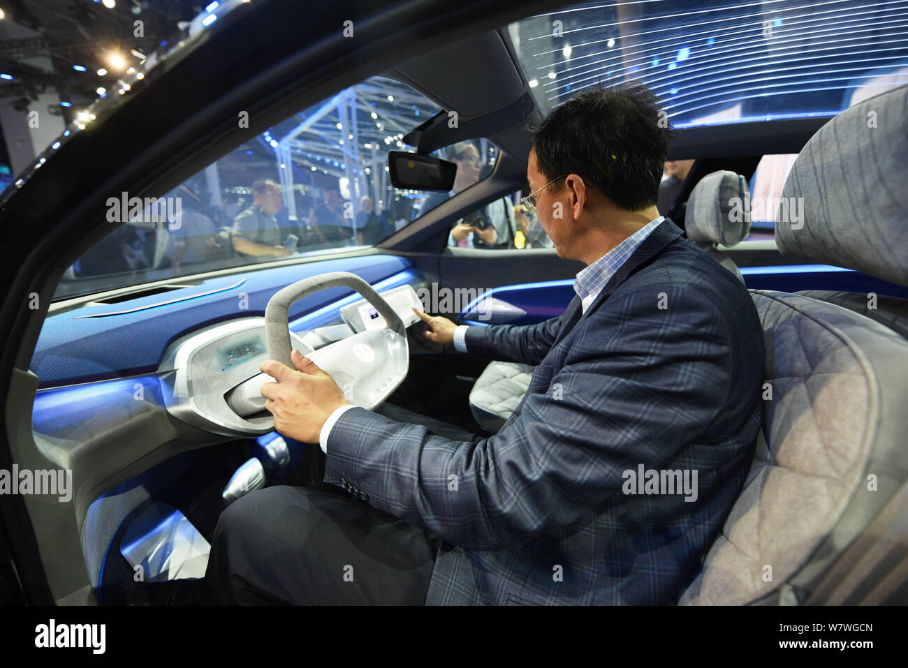 A visitor tries out a Volkswagen I.D. Crozz Electric Crossover Concept ...