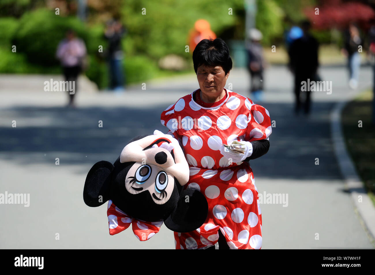 Elderly Chinese woman Yin Pizhi in her 70s, who plays Minnie Mouse to ...