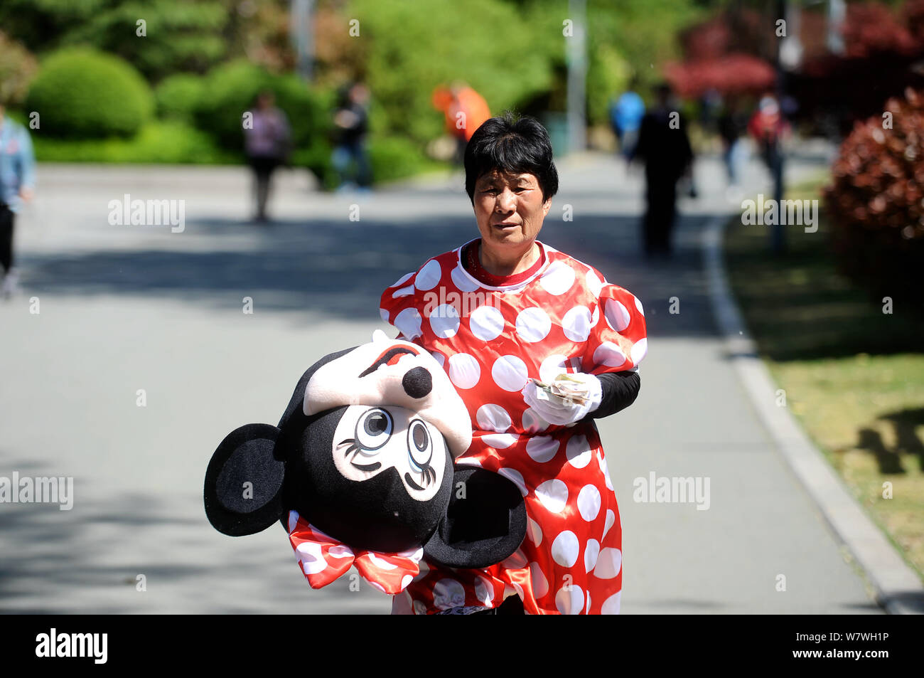 Elderly Chinese woman Yin Pizhi in her 70s, who plays Minnie Mouse to ...