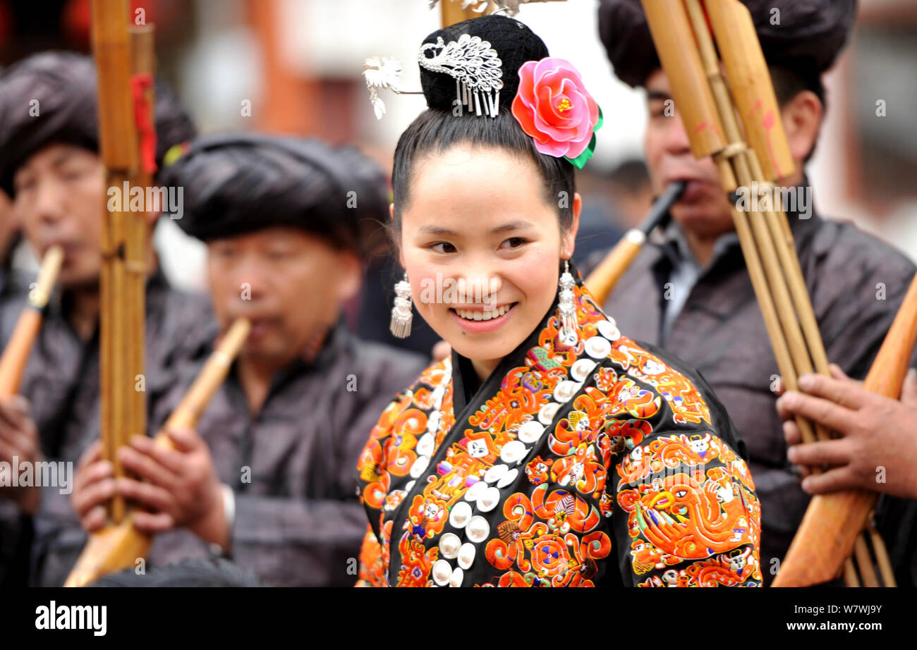 A Chinese girl of Miao ethnic minority dressed in traditional silver ...