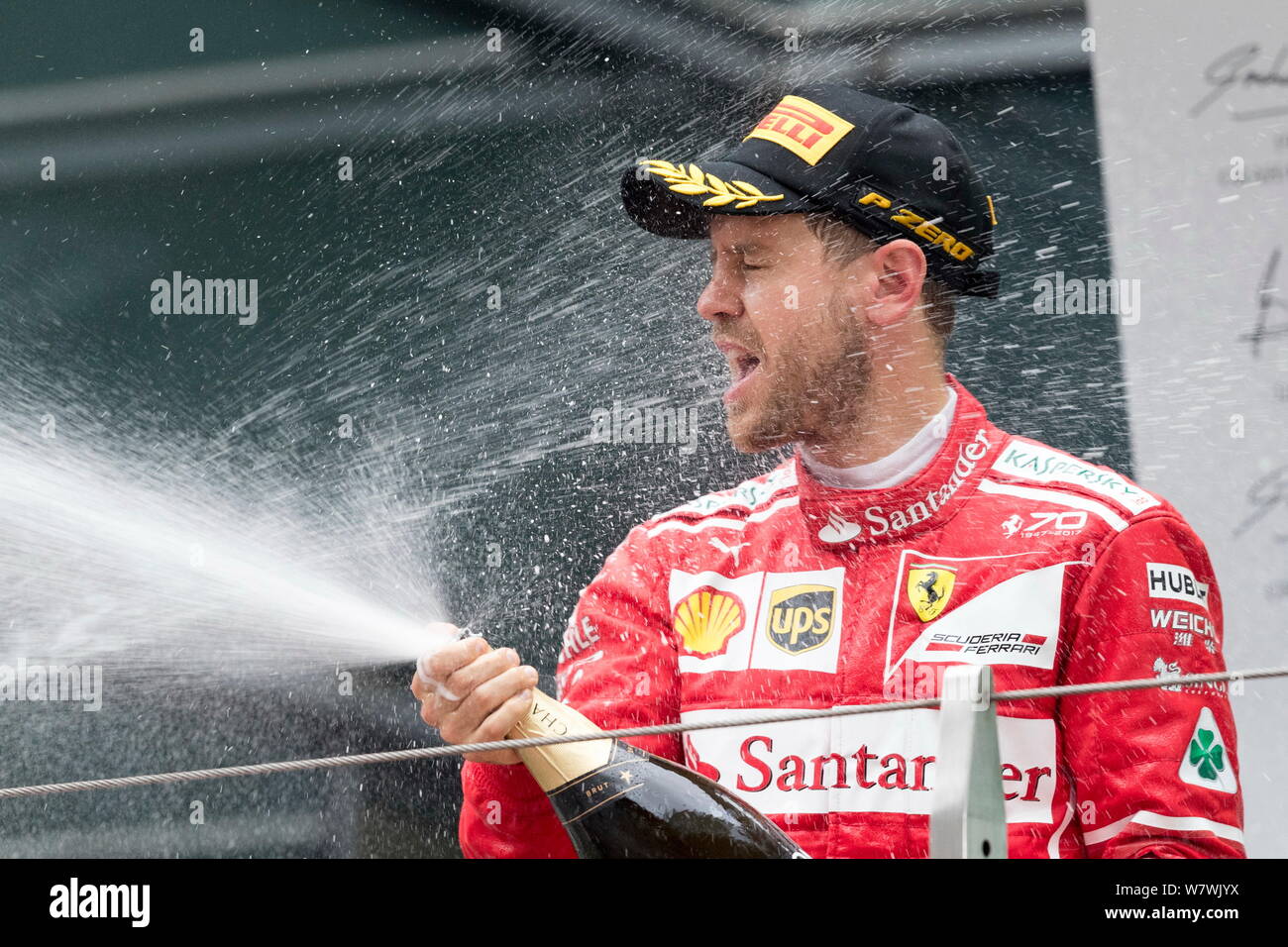 German F1 Sebastian Vettel of Ferrari sprays champagne to celebrate ...