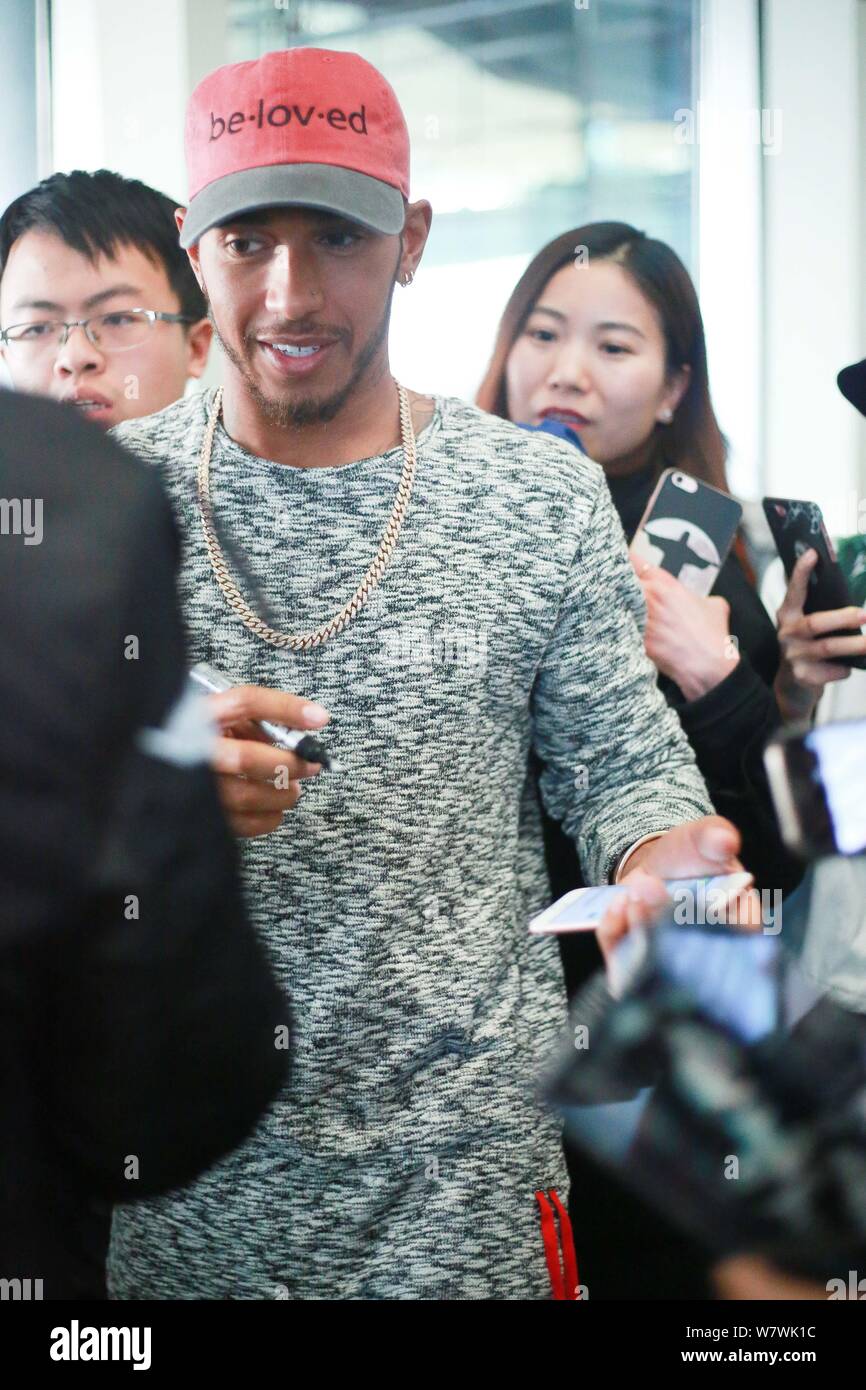 British F1 driver Lewis Hamilton of Mercedes signs autographs for fans ...