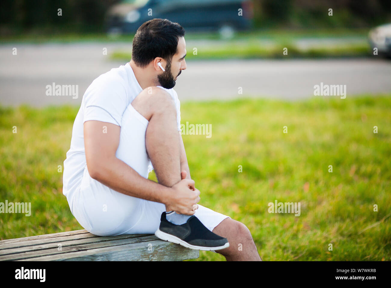 Leg Injury. Male athlete suffering from pain in leg while exercising ...