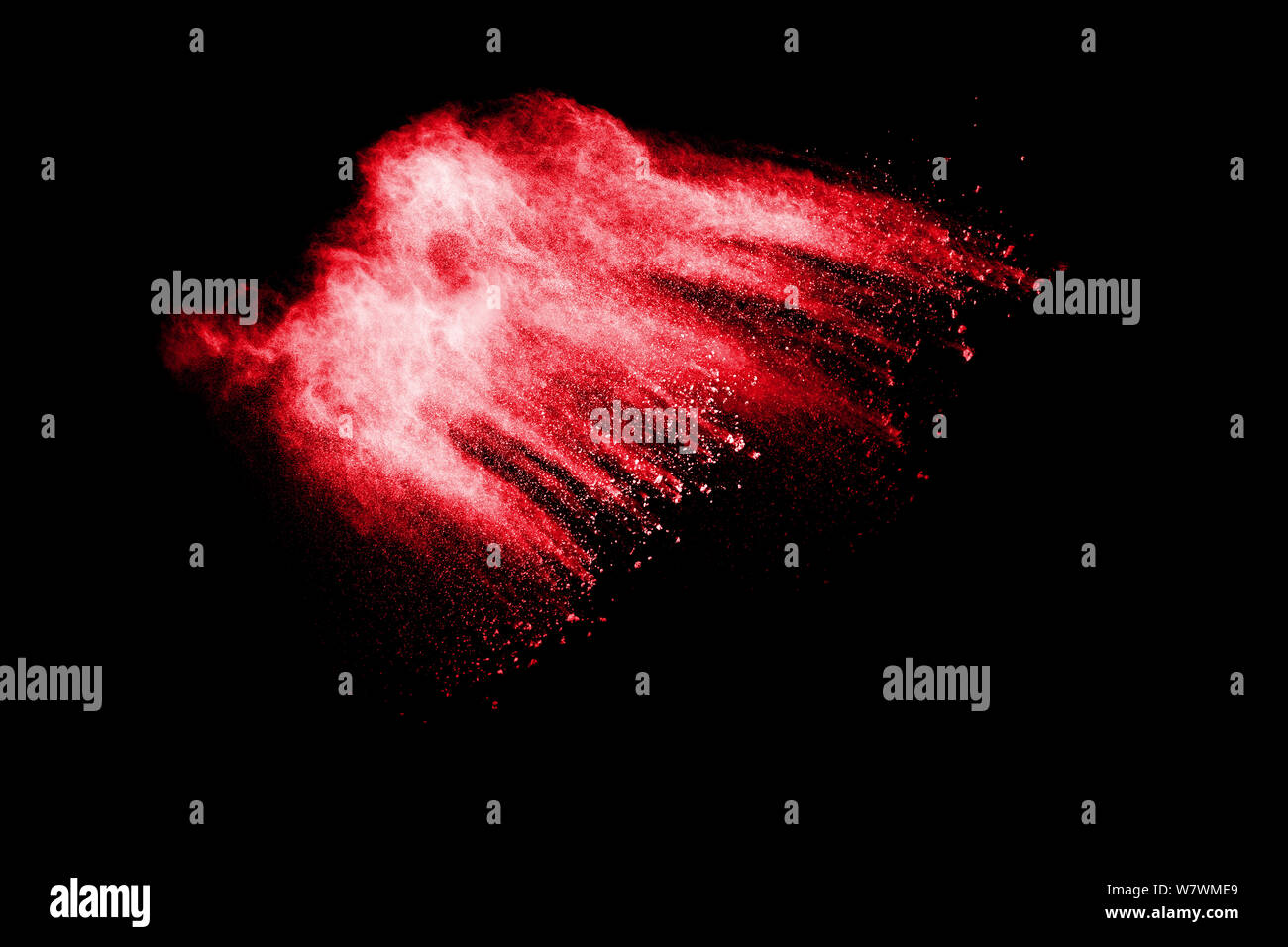 Abstract red dust splattered on white background. Red powder explosion ...