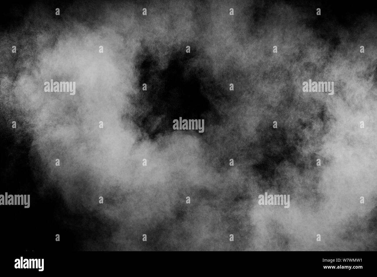 Abstract white powder explosion against black background.White dust ...