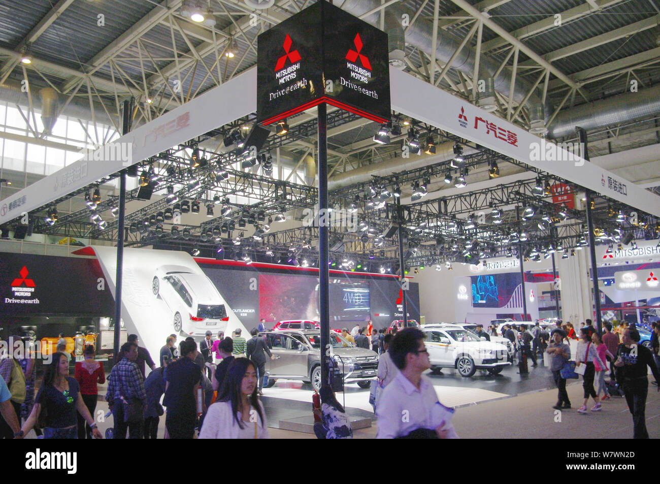 --FILE--Visitors crowd the stand of GAC Mitsubishi Motors during the ...