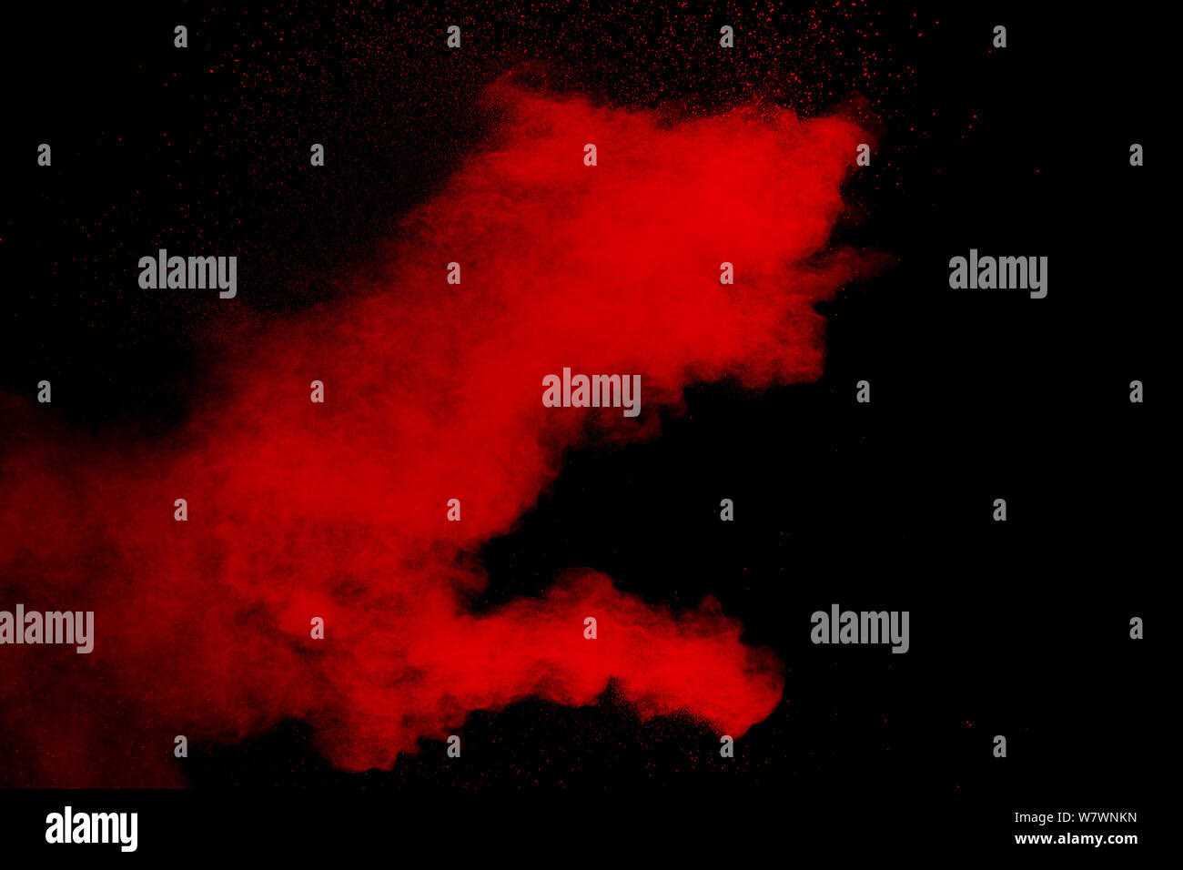 Red color powder explosion on black background.Freeze motion of red ...