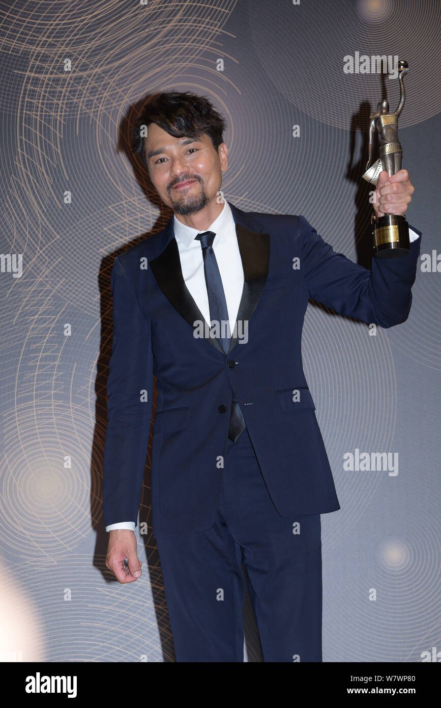 Hong Kong actor Gordon Lam poses with his trophy after winning the Best ...