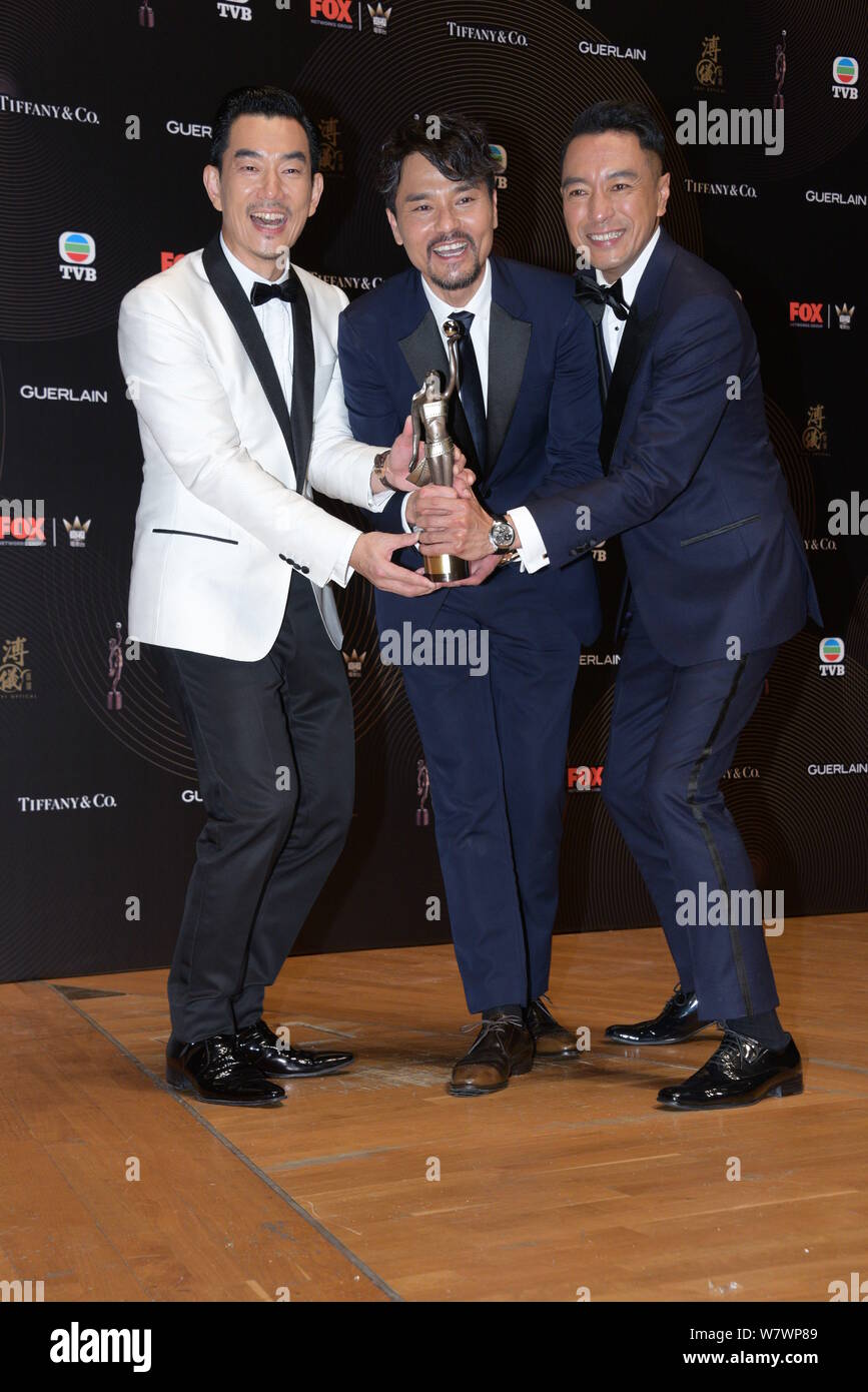 Hong Kong actor Gordon Lam, center, poses with his trophy after winning ...