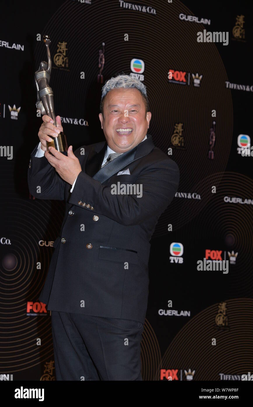 Hong Kong actor Eric Tsang poses with his trophy after winning the Best ...