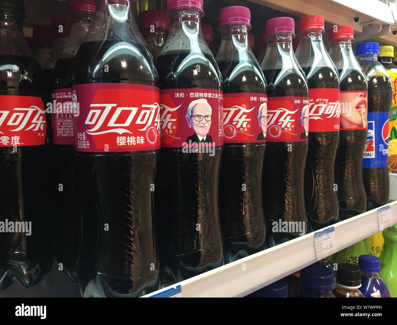 Bottles of Cherry Coca-Cola with a portrait of Warren Buffett, Chairman ...