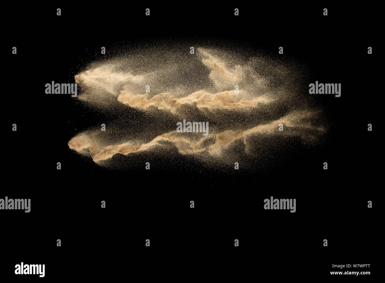 Sand explosion isolated on black background. Freeze motion of sandy ...