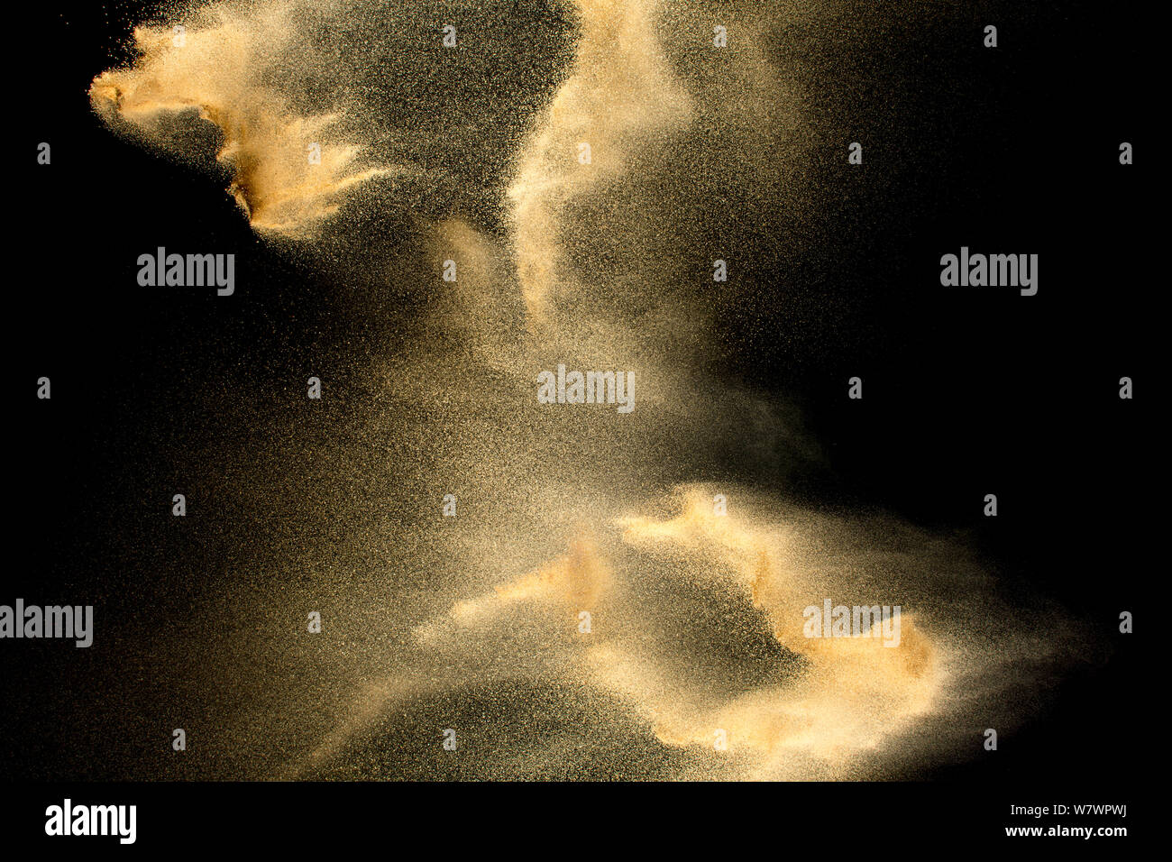 Sand explosion isolated on black background. Freeze motion of sandy ...