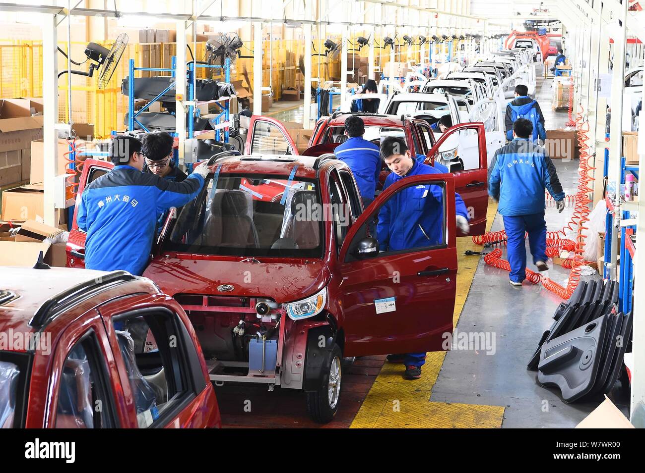 --FILE--Chinese workers assemble electric cars on the assembly line at ...