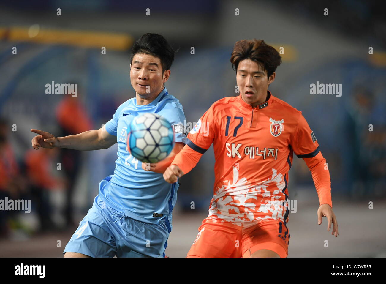 Ji Xiang of China's Jiangsu Suning, left, challenges Ahn Hyun-beom of ...