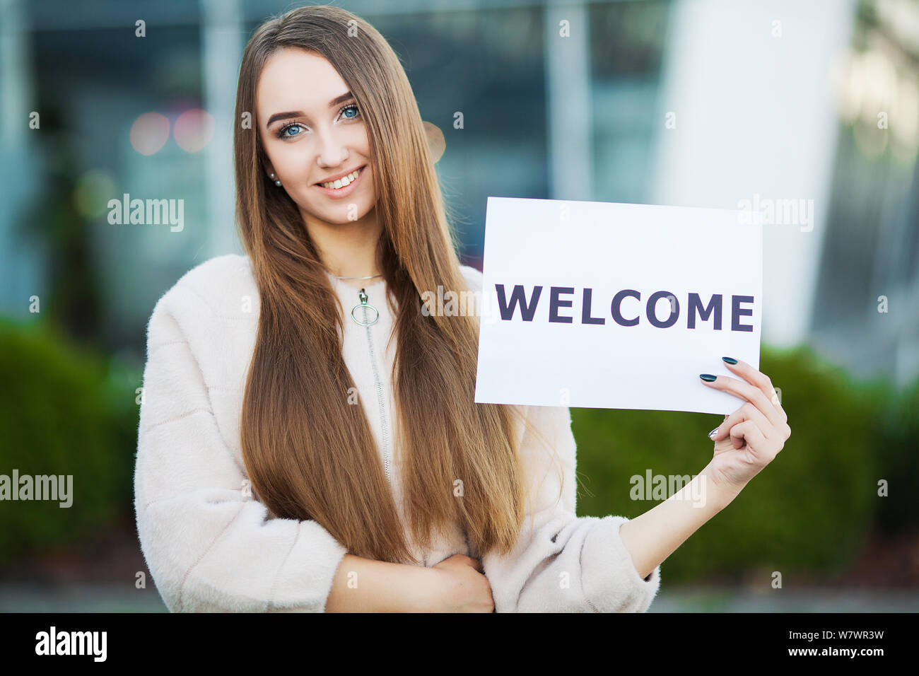 Women business with the poster with welcome message Stock Photo - Alamy