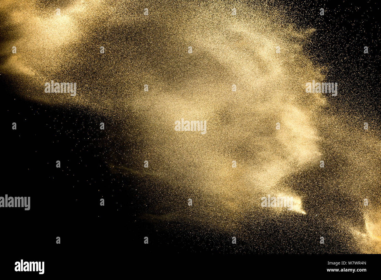 Sand explosion isolated on black background. Freeze motion of sandy ...