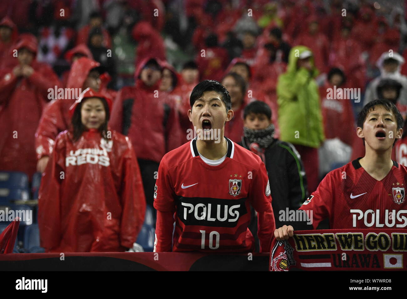 Football fans brave rain and shout slogans to show support for Japan's ...