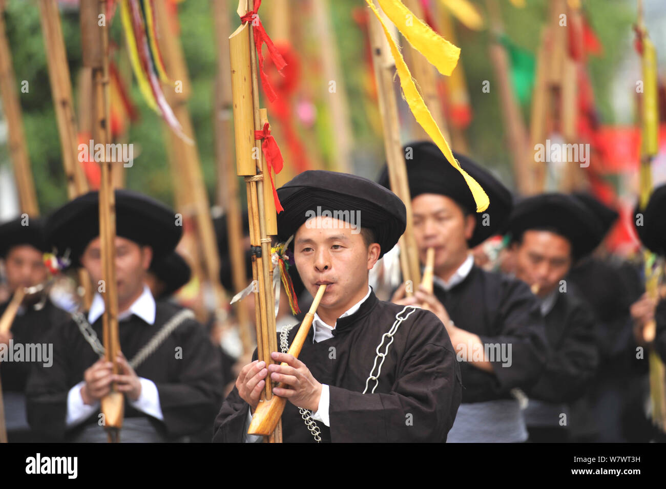 Chinese men of Miao ethnic minority wearing traditional costumes take ...