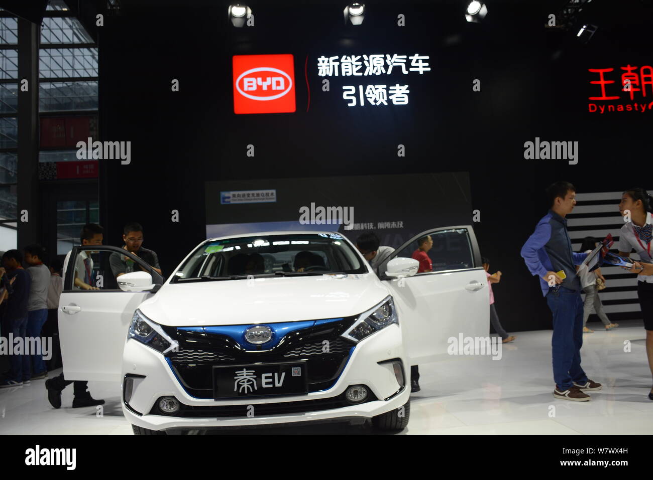 --FILE--Chinese customers try out a BYD Qin electric vehicle on display ...