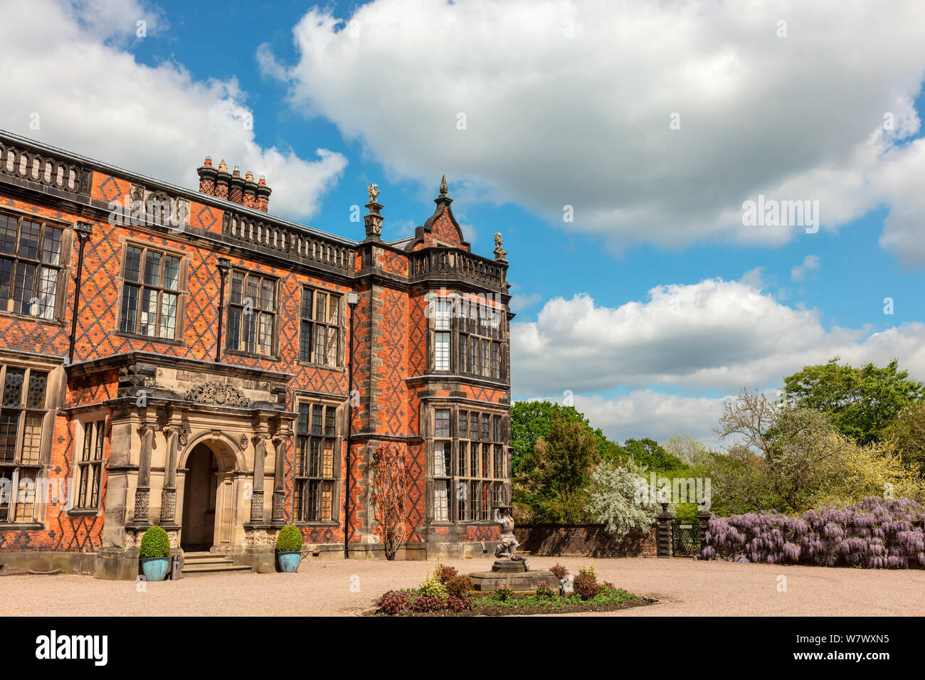 Historic English stately home built in red brick and surrounding park ...