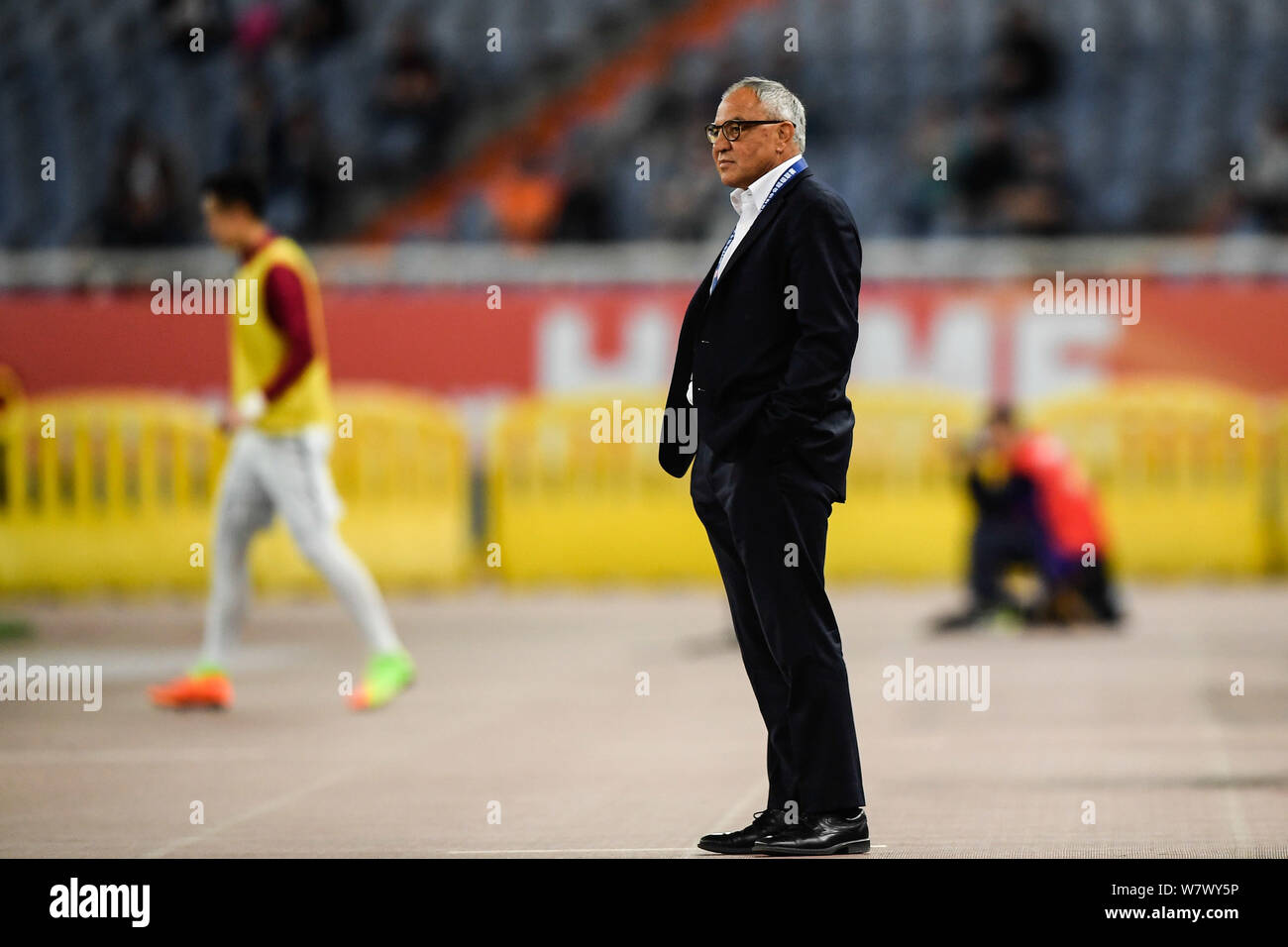 Head coach Felix Magath of Shandong Luneng watches his players ...