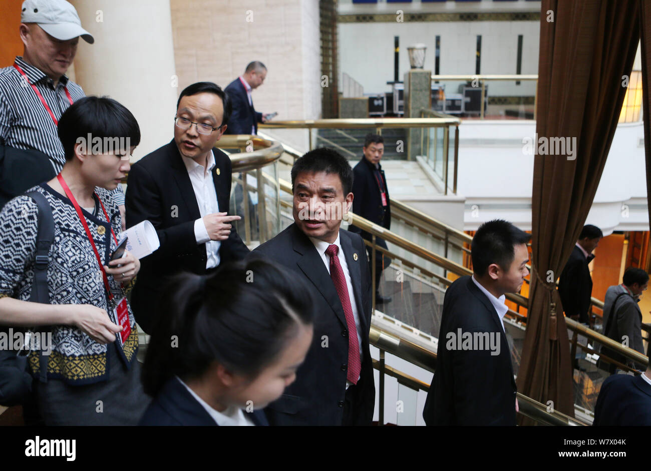 Liu Yonghao, center, Chairman of New Hope Group, attends a Sichuan ...