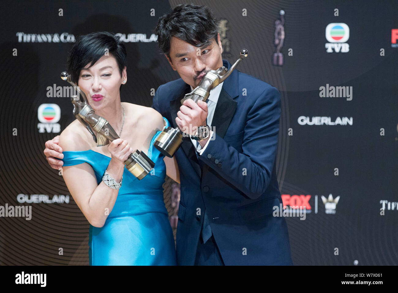 Hong Kong actress Kara Wai, left, and actor Gordon Lam kiss their ...