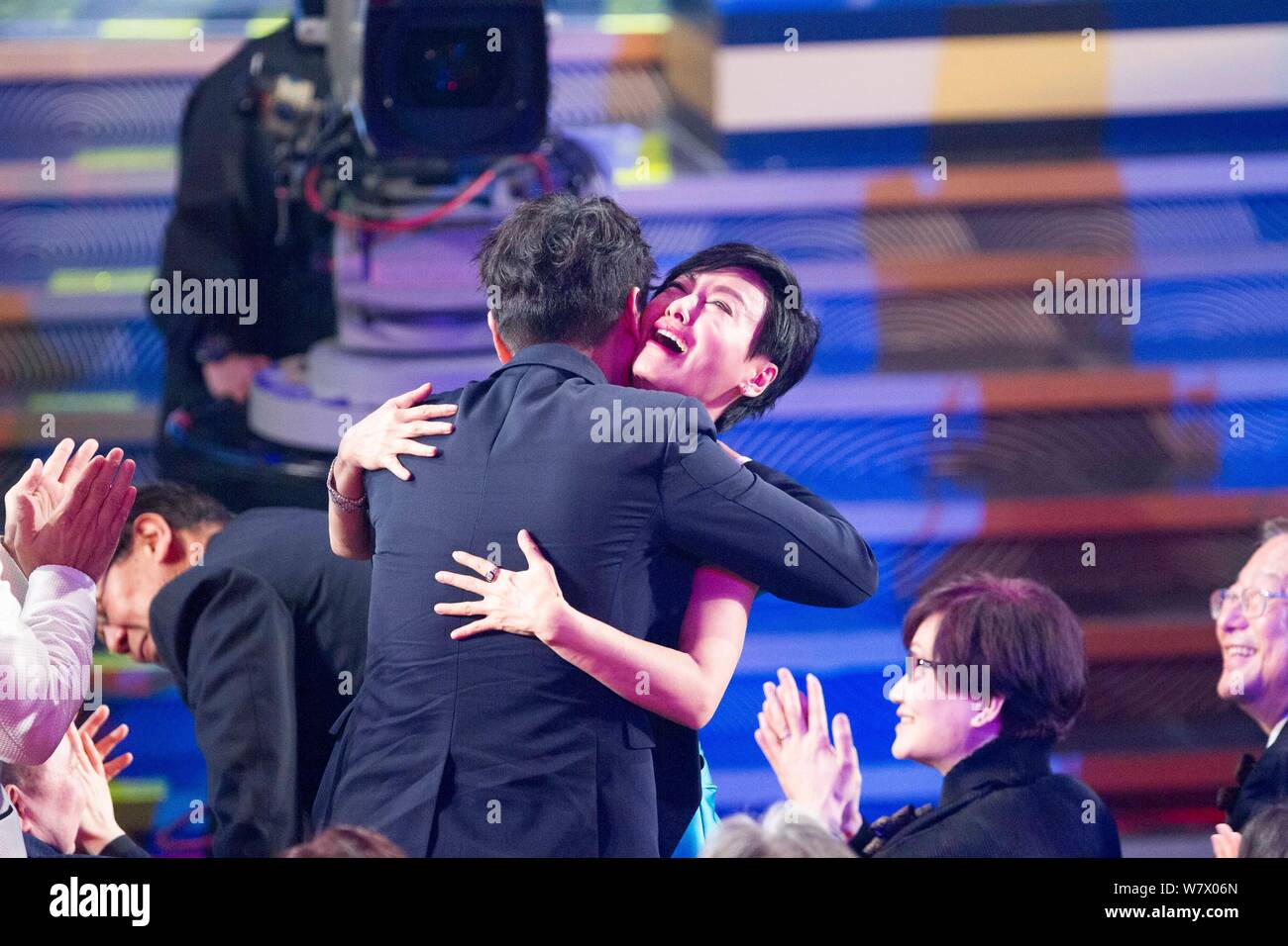 Hong Kong actress Kara Wai, right, hugs actor Gordon Lam after winning ...