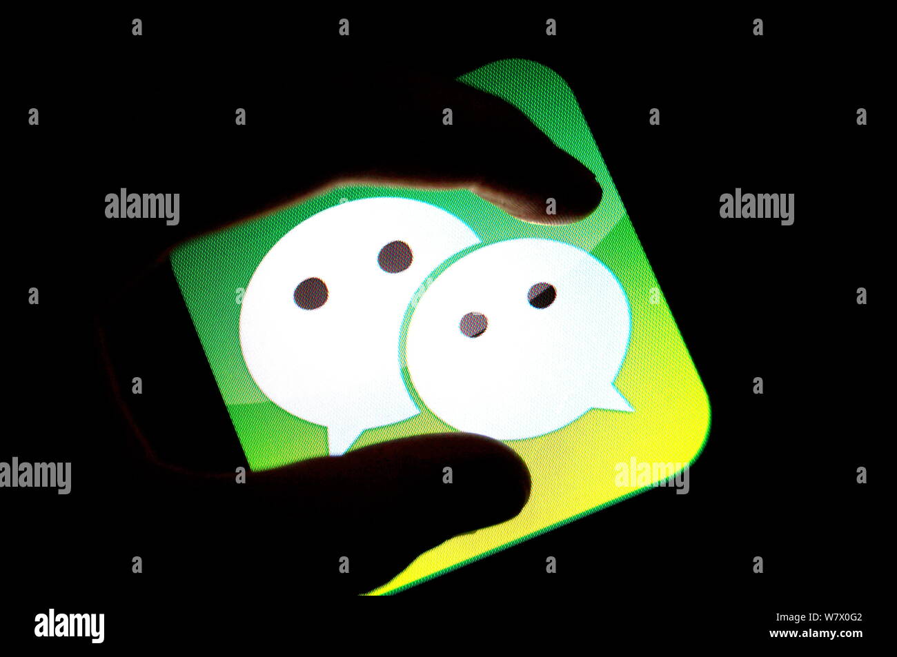 --FILE--A Chinese netizen looks at a logo of the messaging app Weixin ...