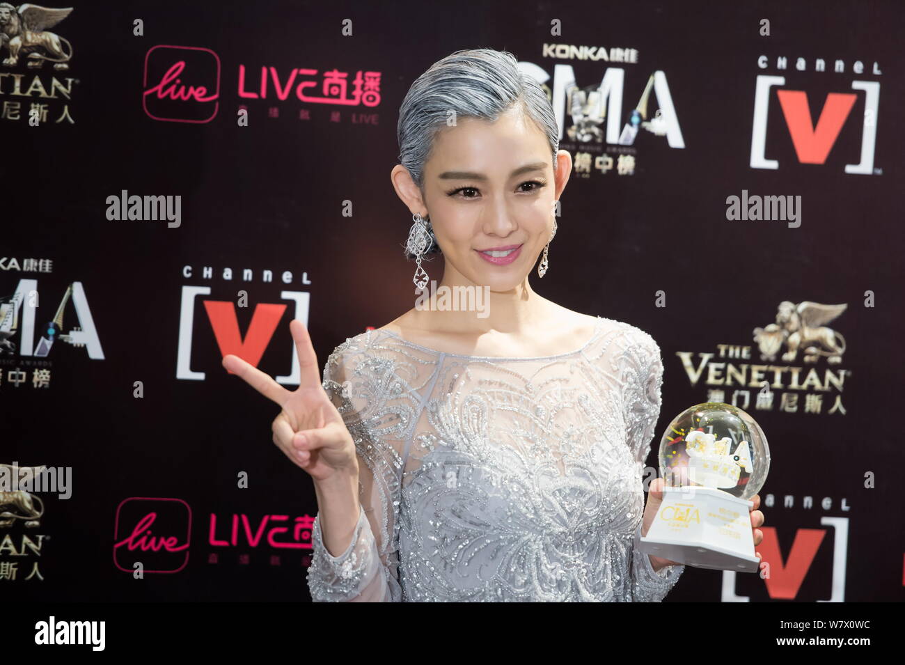 Taiwanese singer and actress Christine Fan poses with her trophies ...