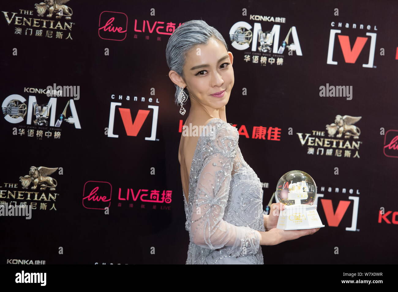 Taiwanese singer and actress Christine Fan poses with her trophies ...