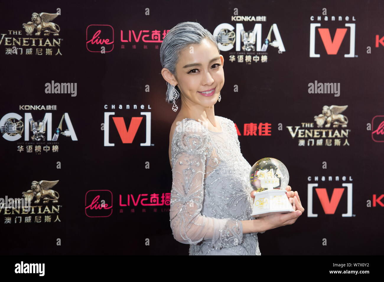 Taiwanese singer and actress Christine Fan poses with her trophies ...
