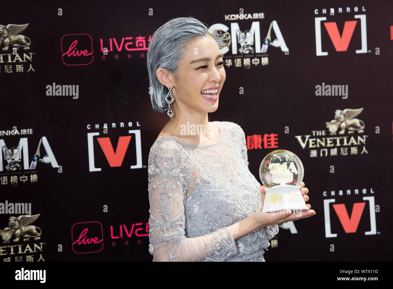 Taiwanese singer and actress Christine Fan poses with her trophies ...
