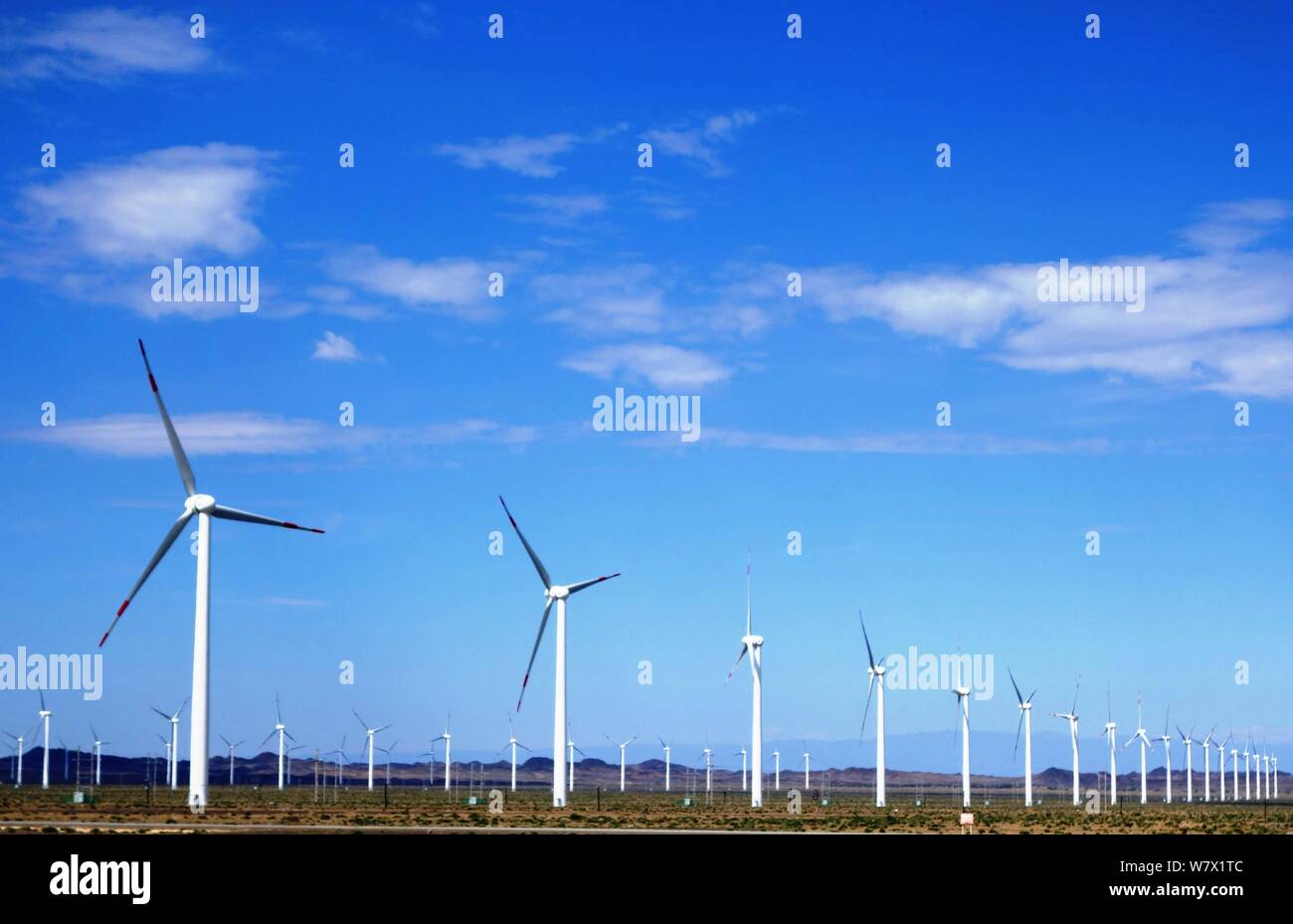 --FILE--Wind turbines whirl to generate electricity at a wind farm in ...