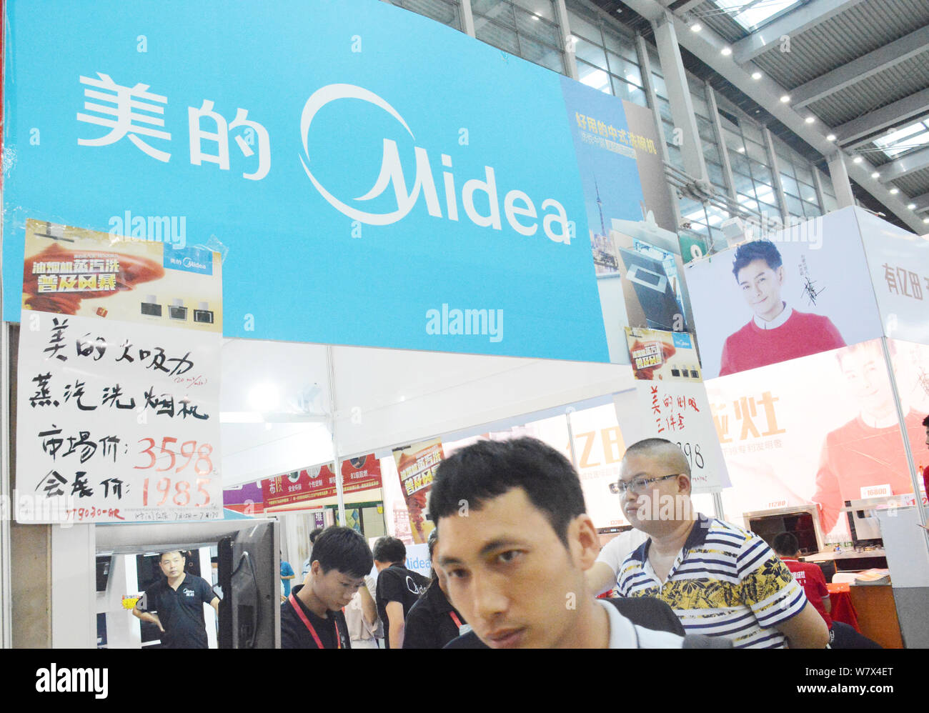 --FILE--Visitors walk past the stand of Media at Shenzhen exhibition ...