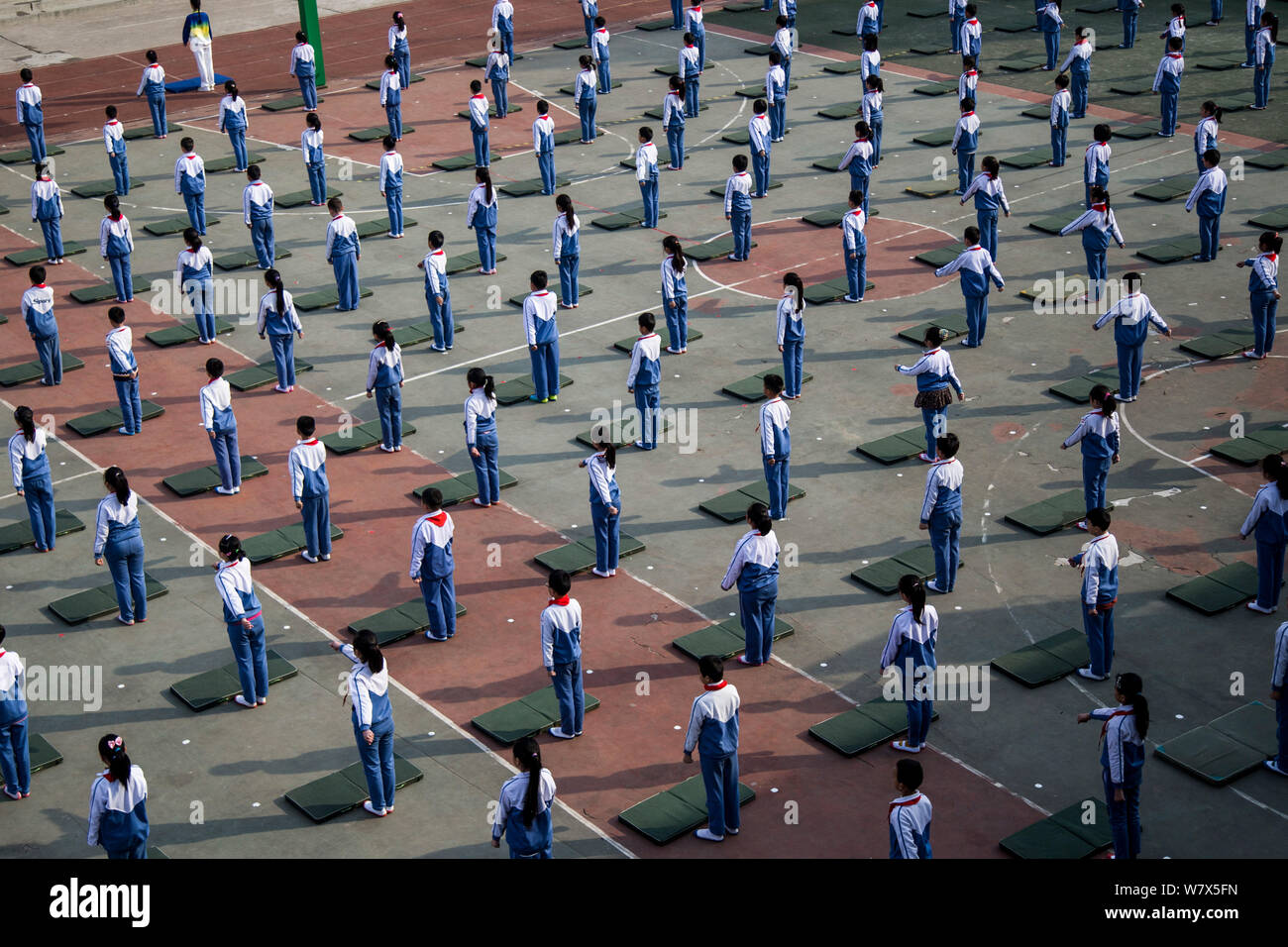 Chinese students prepare to practice gymnastics and yoga during class ...