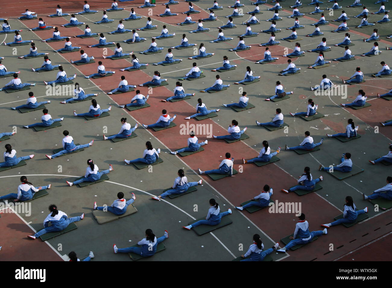 Chinese students practice gymnastics and yoga during class break on the ...