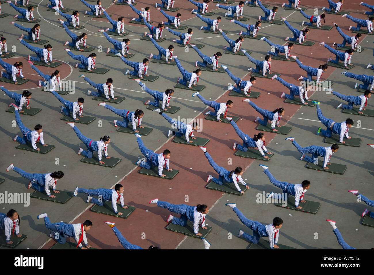 Chinese students practice gymnastics and yoga during class break on the ...