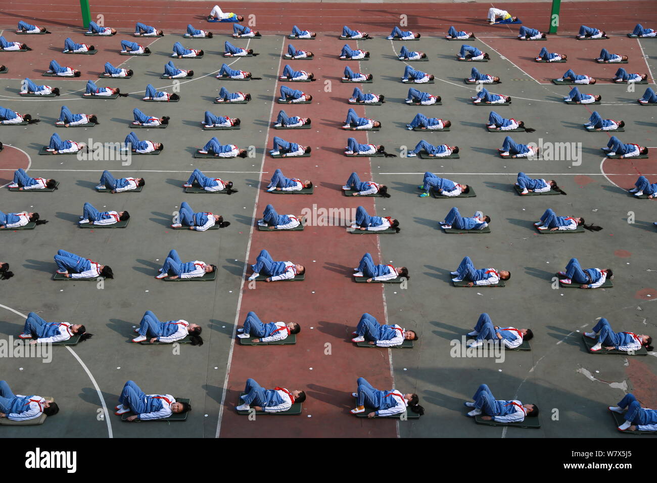 Chinese students practice gymnastics and yoga during class break on the ...