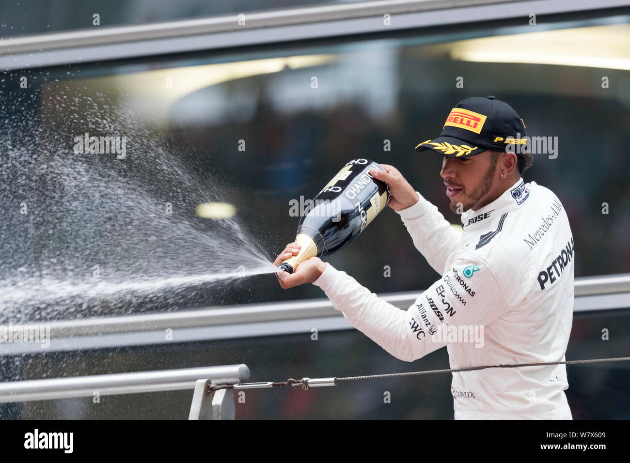 British F1 driver Lewis Hamilton of Mercedes sprays champagne to ...