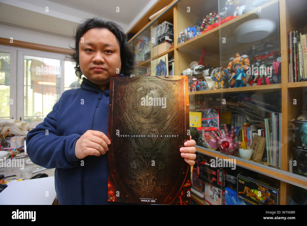 Chinese Transformers fan Wang Geng shows a poster of the movie ...