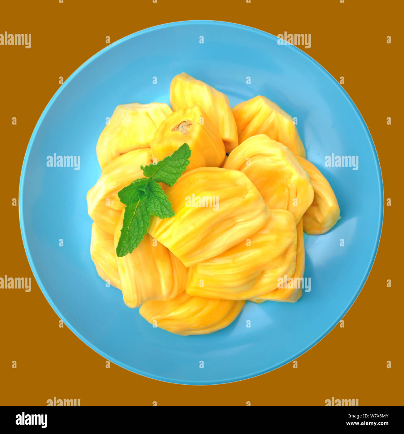 Tropical fruit jackfruit on red plate on blue Stock Photo - Alamy